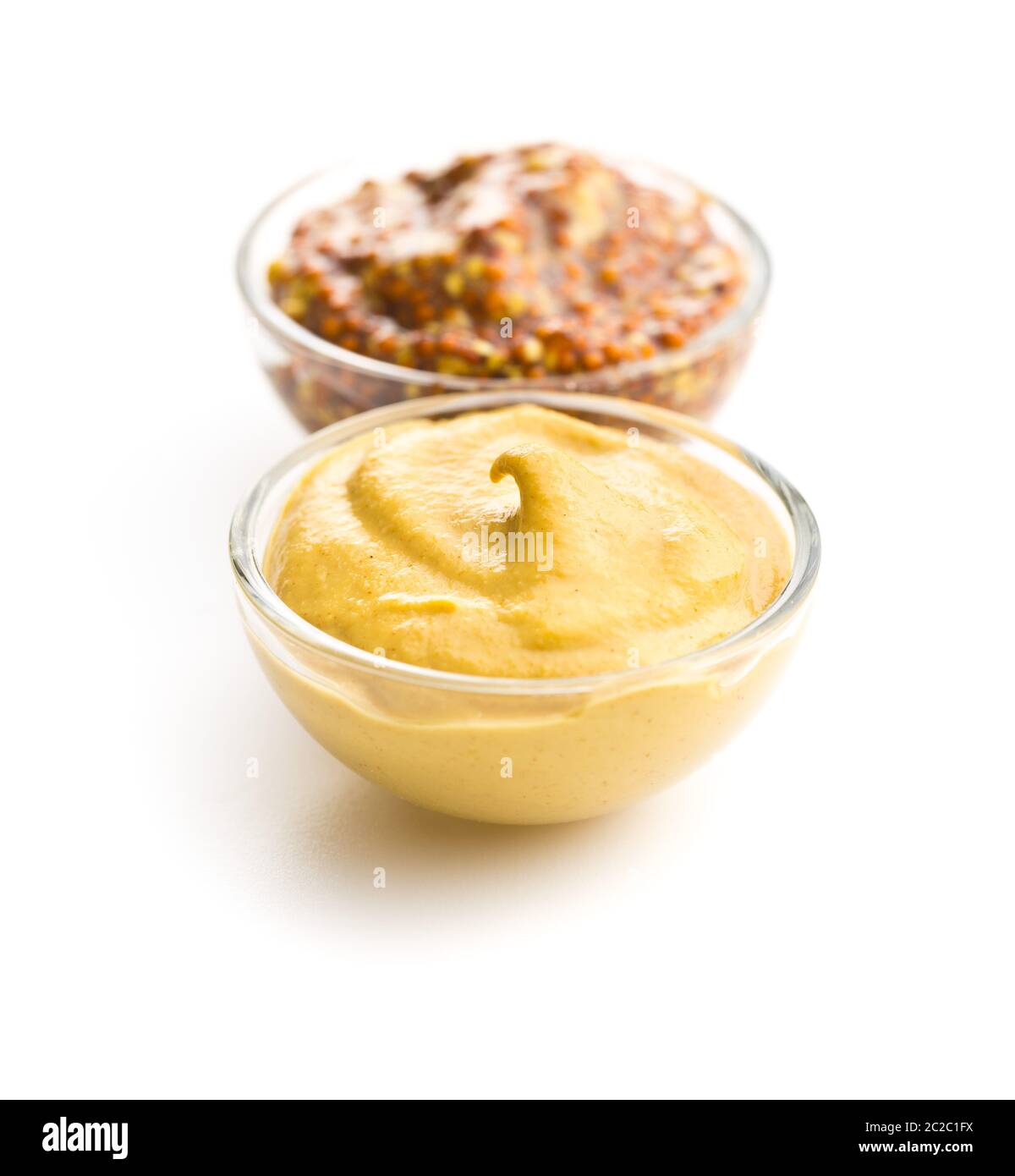 Yellow mustard and whole grain mustard isolated on white background ...