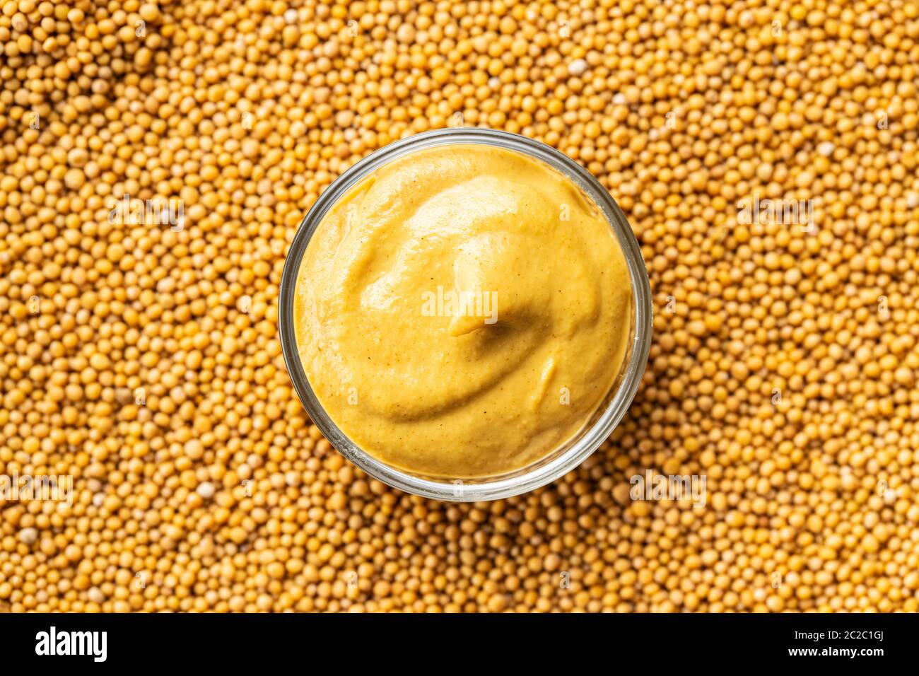 Yellow mustard and mustard seeds. Top view Stock Photo - Alamy