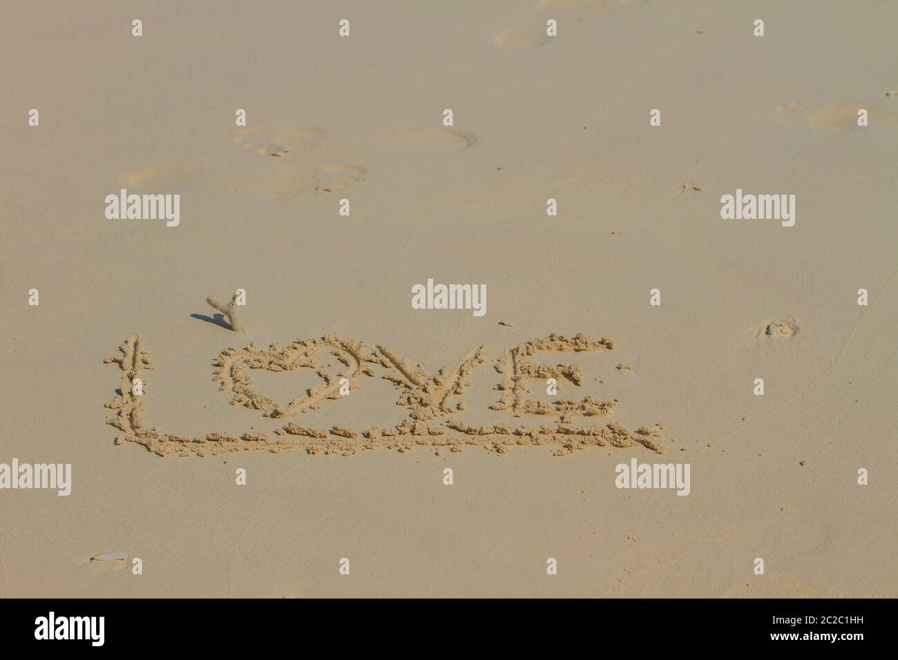 Word LOVE on sand, Drawing love word on beach Stock Photo - Alamy