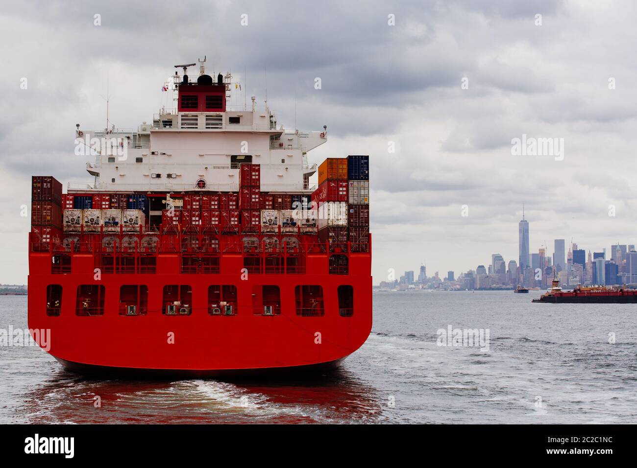 Container ship on East River with Lower Manhattan Skyline, New York USA ...