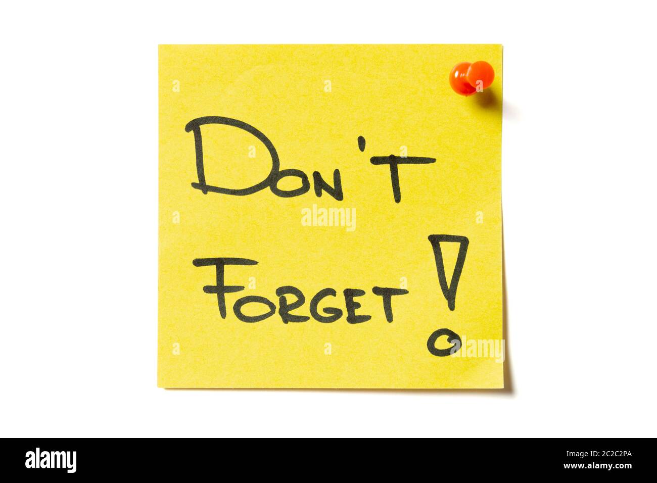 Sticky note message on yellow sticky note pinned to white background ...