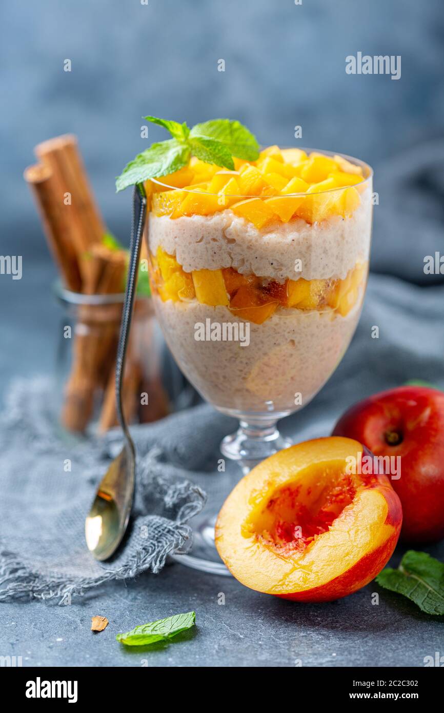 Rice pudding with peach slices and spices Stock Photo - Alamy