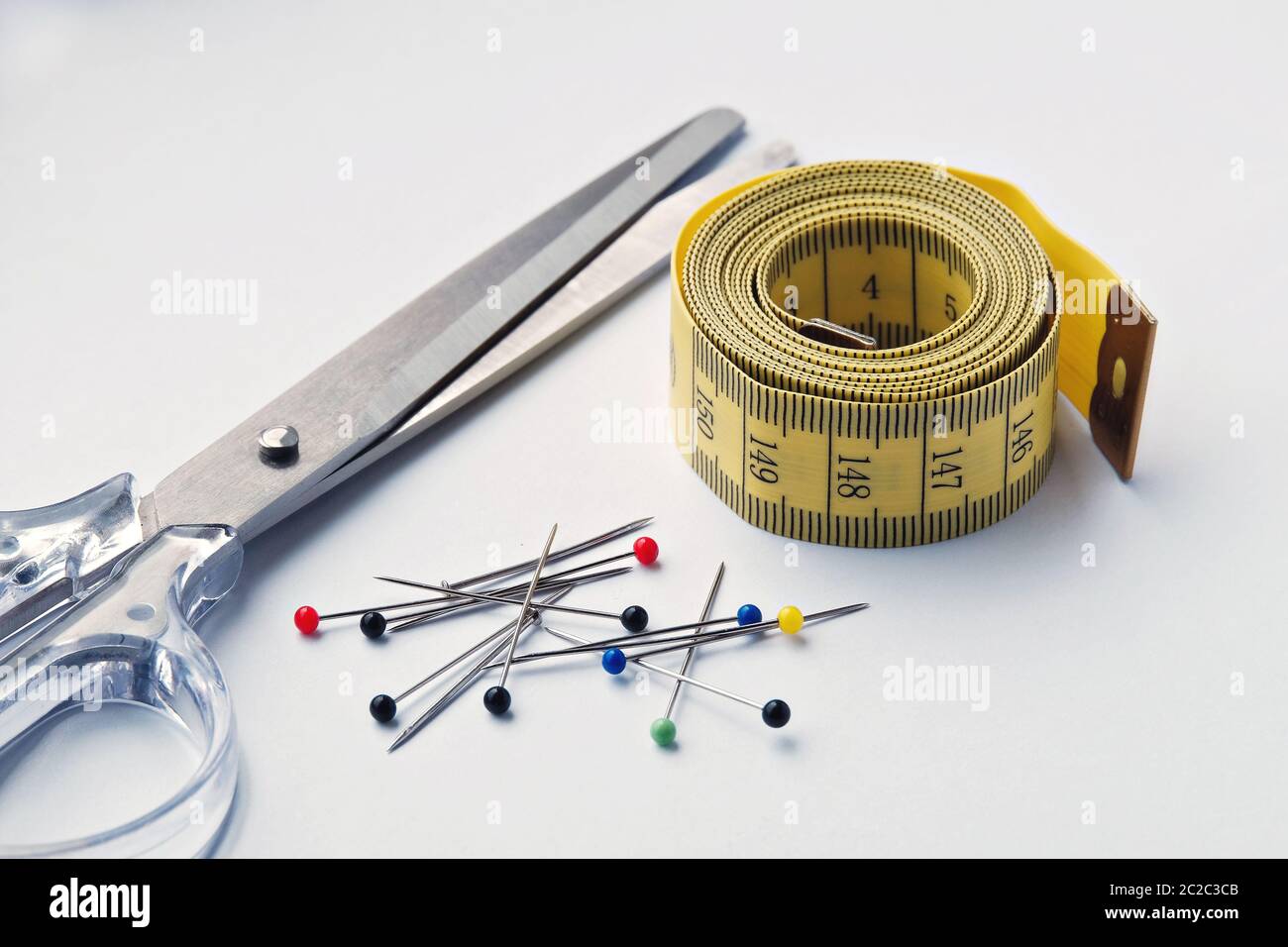 Set for needlework with cissors, measure tape and colored pins isolated ...