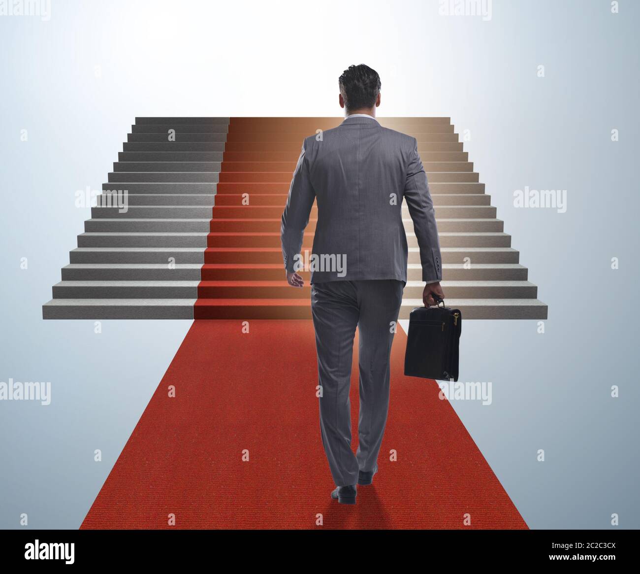 Young businessman climbing stairs and red carpet Stock Photo - Alamy