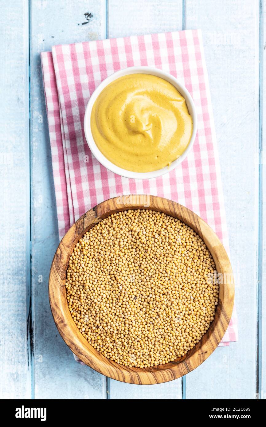 Mustard seeds and yellow mustard. Top view Stock Photo - Alamy