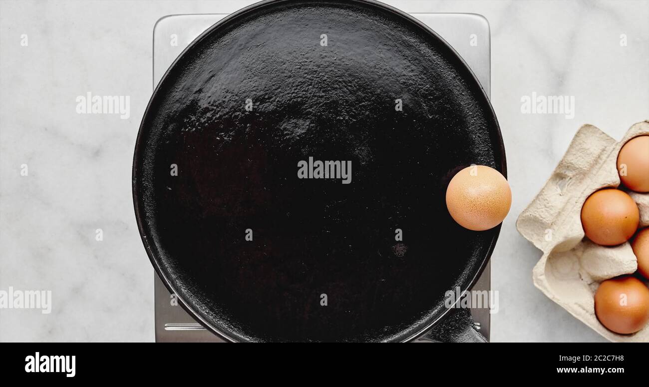 Animation of an egg frying itself in a hot pan jumping from a carton to ...