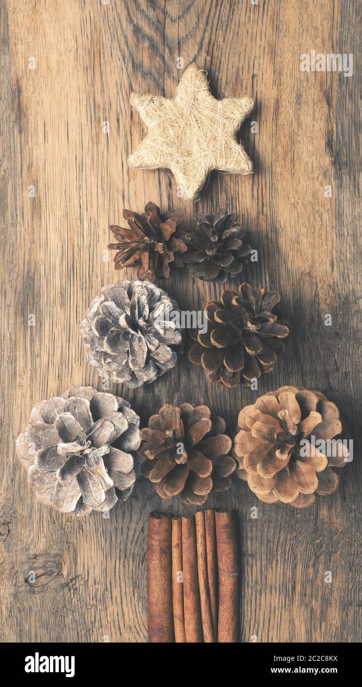 Christmas tree shape of pine cones with a handmade star shape on a ...