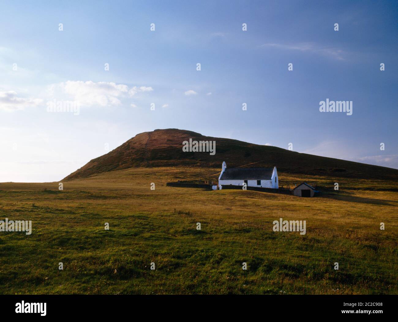 View NW of Holy Cross church sheltered by Foel y Mwnt headland ...