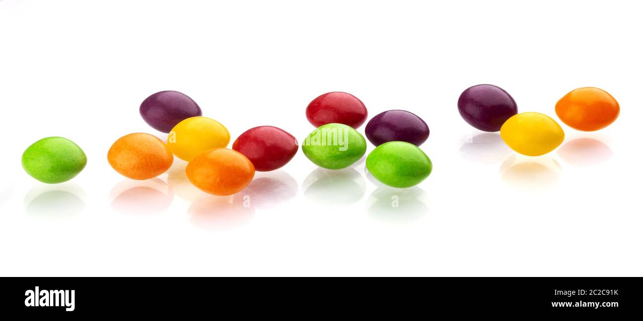 Multicolor shiny nuts and raisins dragee isolated on white background ...