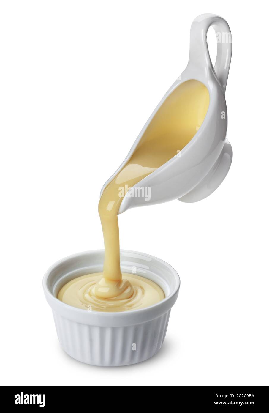 Pouring condensed milk isolated on white background Stock Photo - Alamy