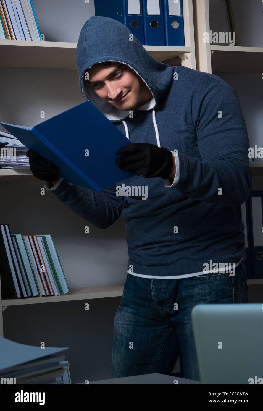 Young man in industrial espionage concept Stock Photo - Alamy