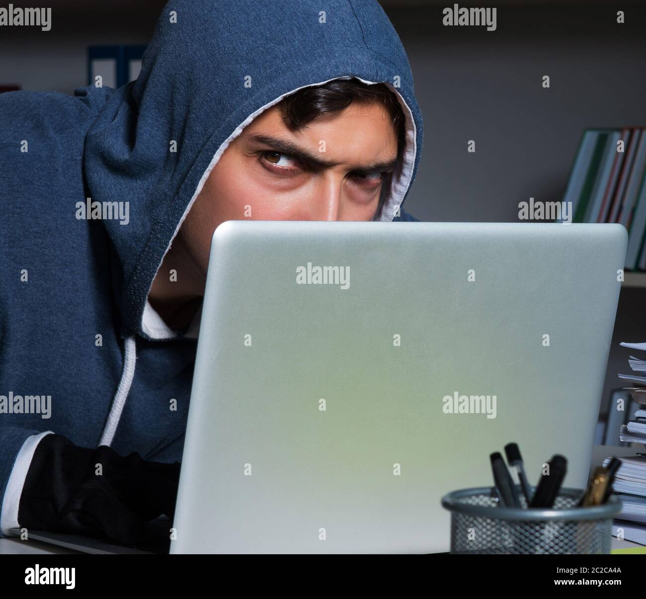 Young hacker hacking into computer at night Stock Photo - Alamy