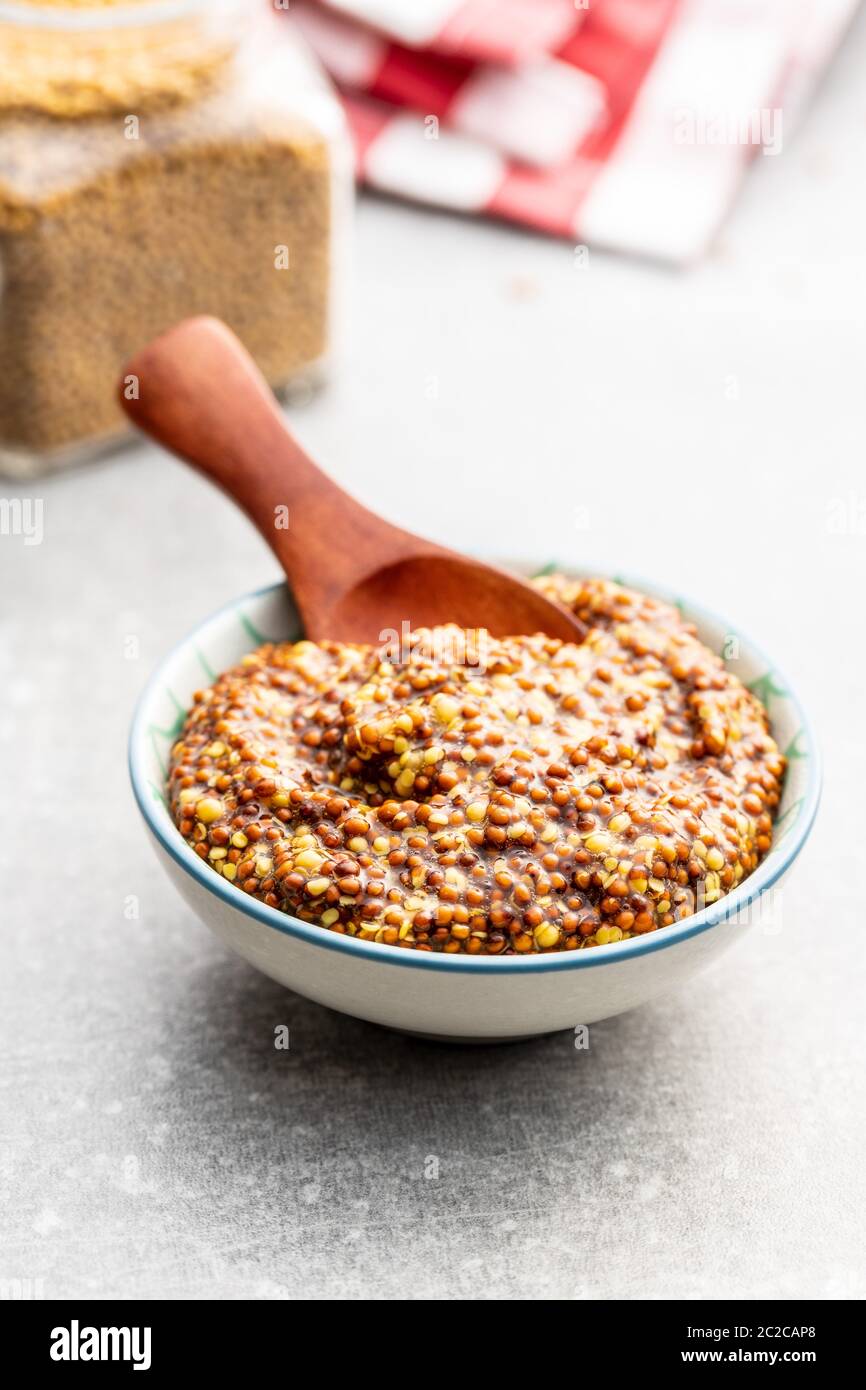 Whole grain mustard in bowl on kitchen table Stock Photo - Alamy