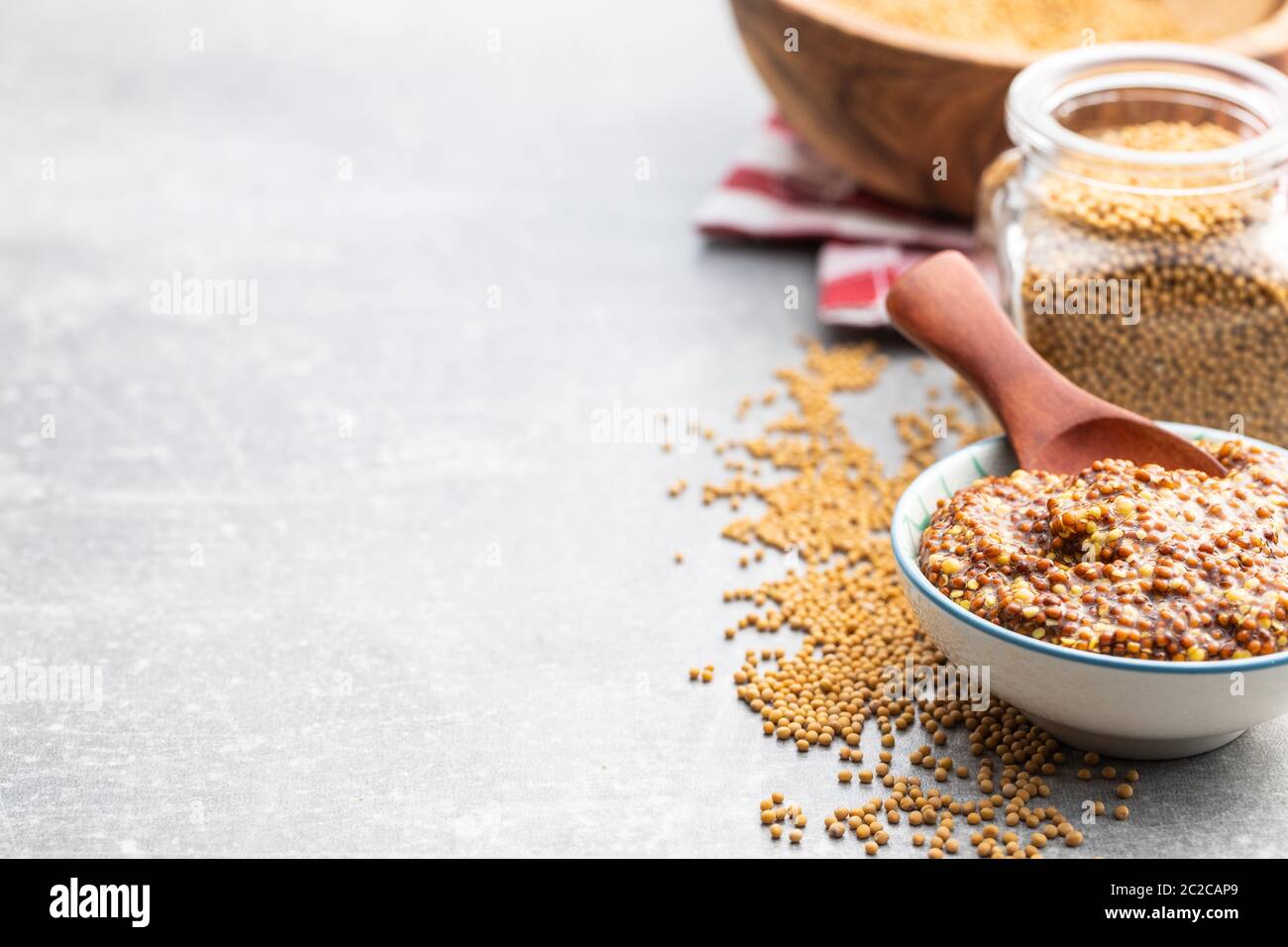 Whole grain mustard and mustard seeds on kitchen table Stock Photo - Alamy