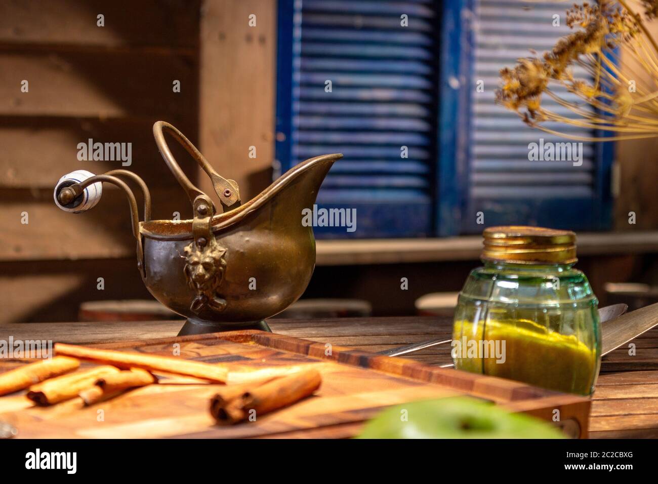 Copper vintage jug on a wooden table. Still life in vintage rural style ...