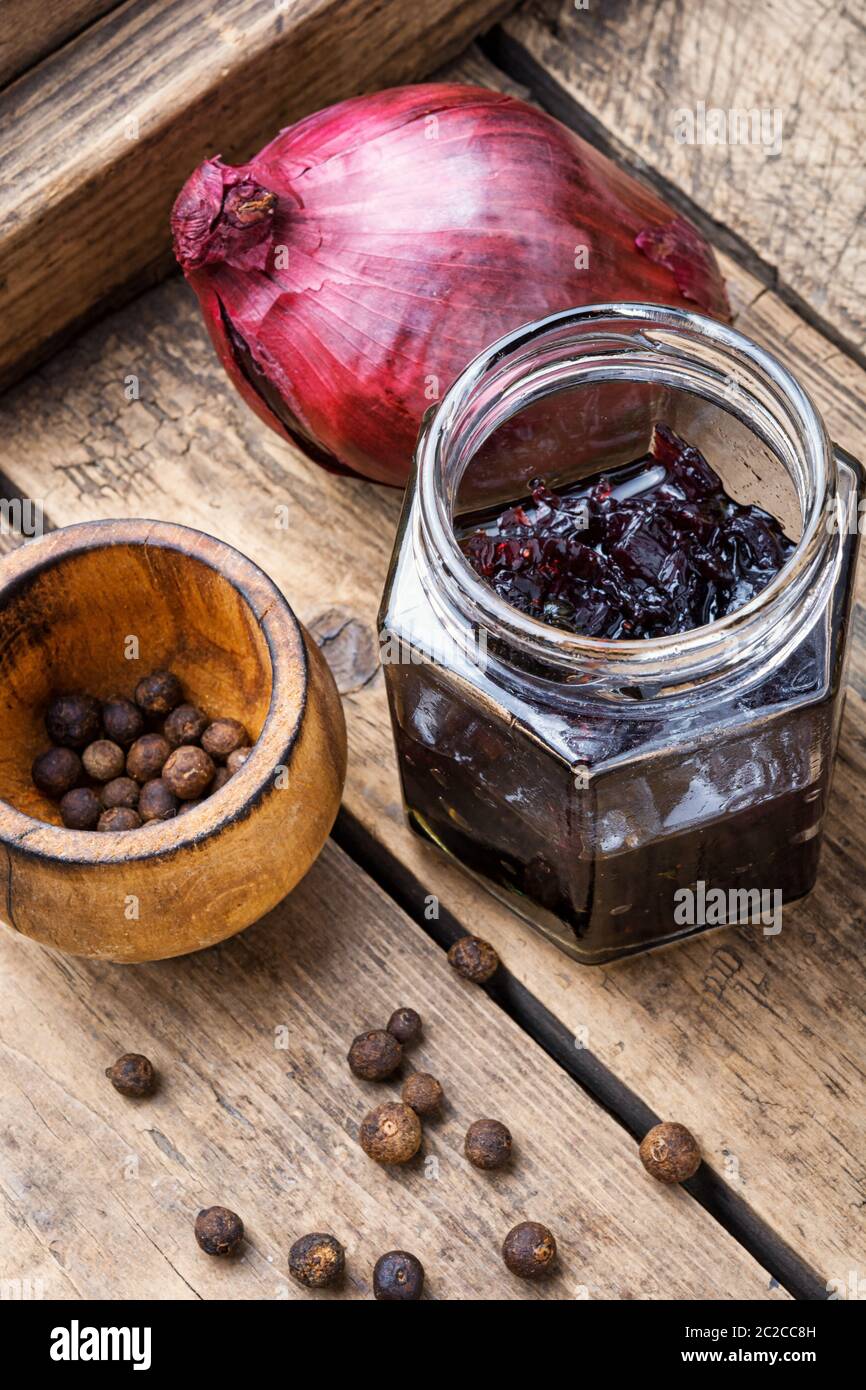 Homemade red onion jam.Onion confiture on old wooden table Stock Photo ...