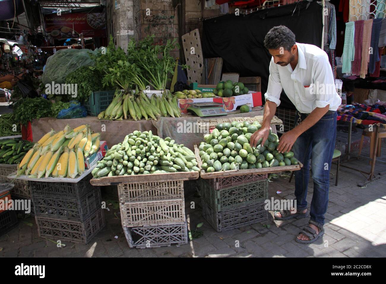 Gaza. 15th June, 2020. A Palestinian vendor arranges vegetables at a ...