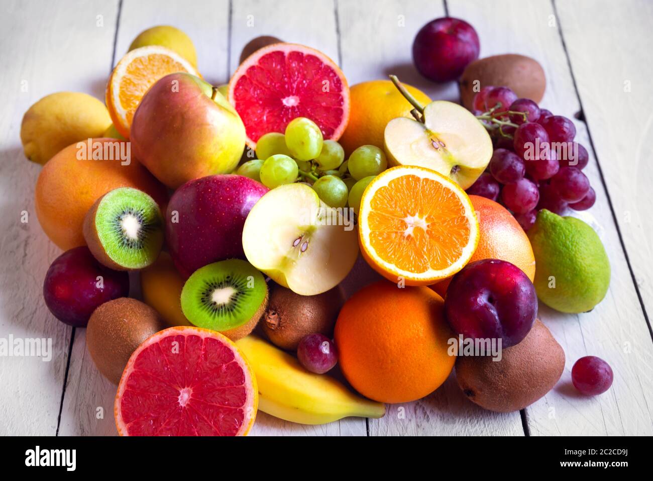 Fresh whole and cut fruit, orange, apple, kiwi, grapes and other fruits ...