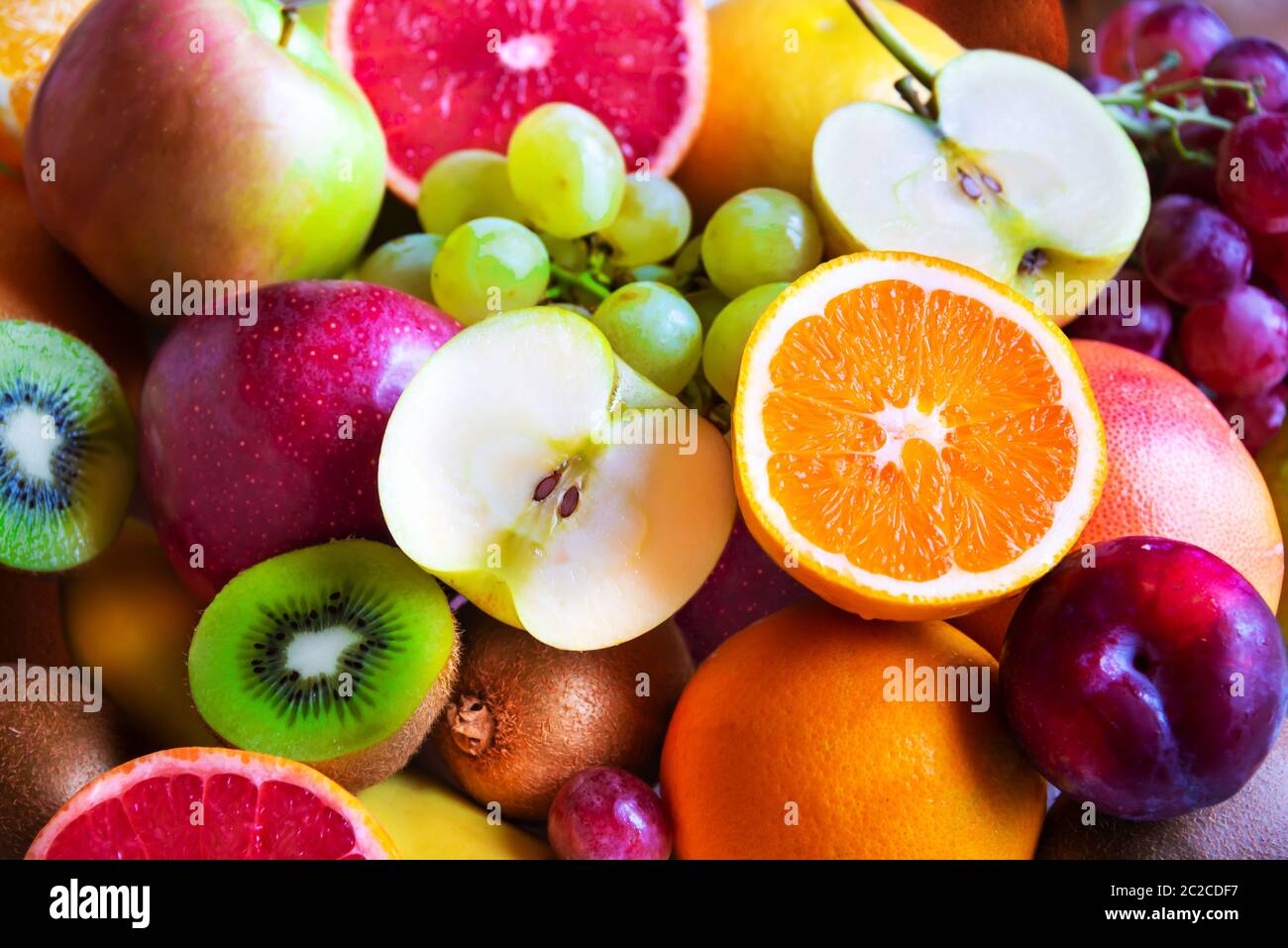 Fresh whole and cut fruit, orange, apple, kiwi, grapes and other fruits ...