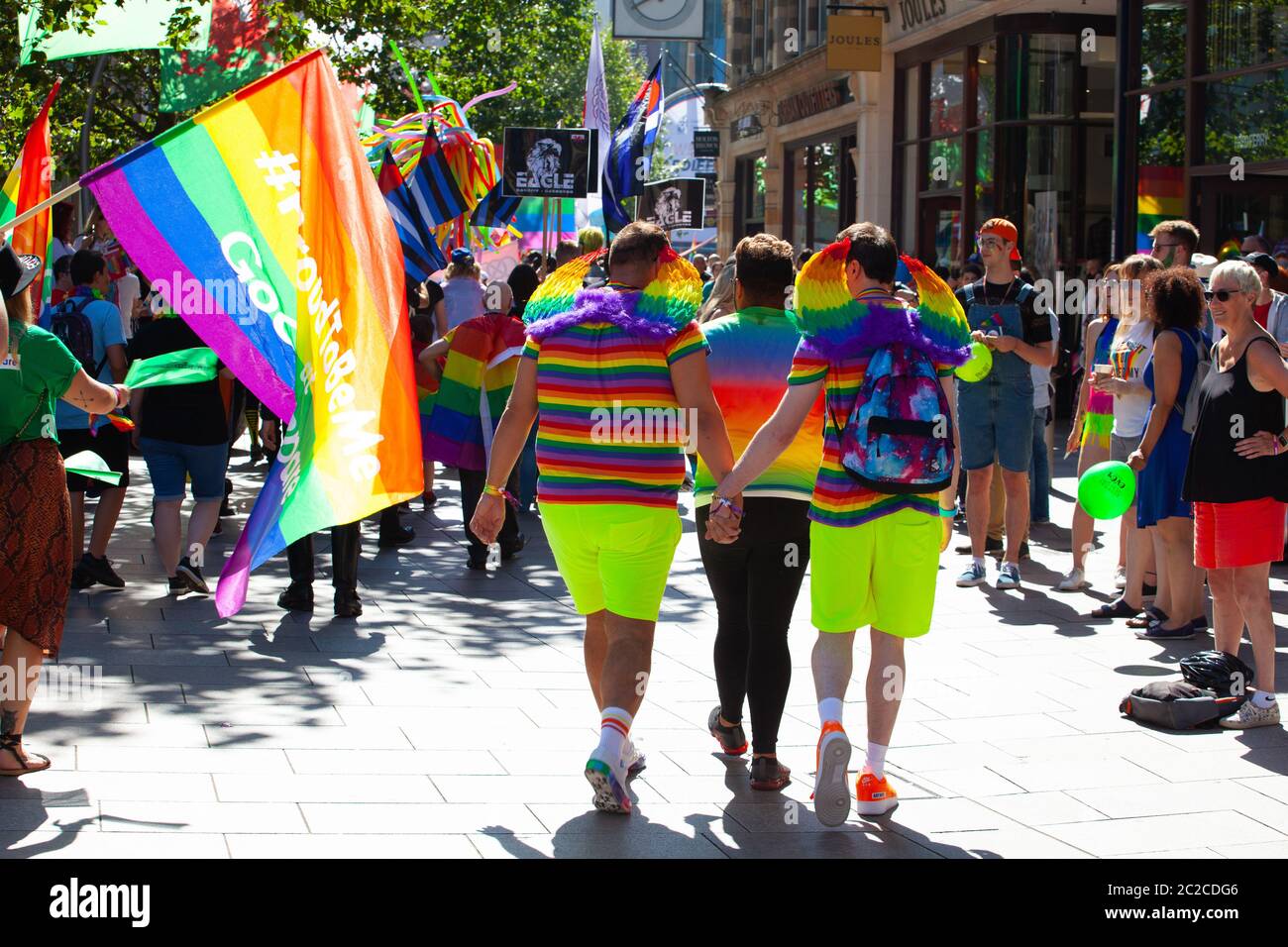 Two flamboyantly dressed men holding hands at the 2019 Pride Cymru ...