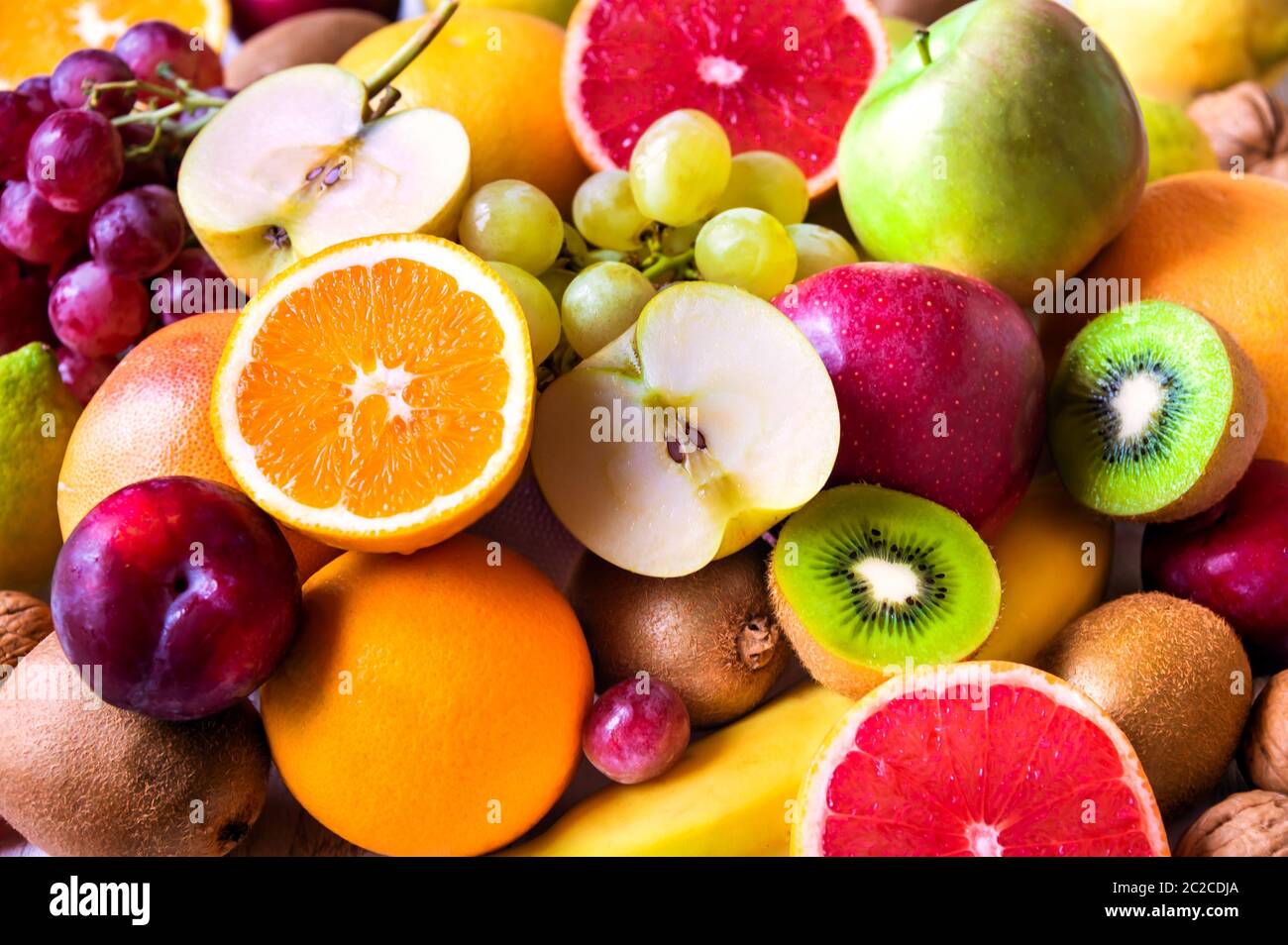 Fresh whole and cut fruit, orange, apple, kiwi, grapes and other fruits ...