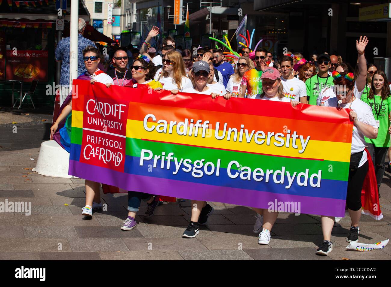 Cardiff University bilingual banner and marchers at the 2019 Gay Pride ...