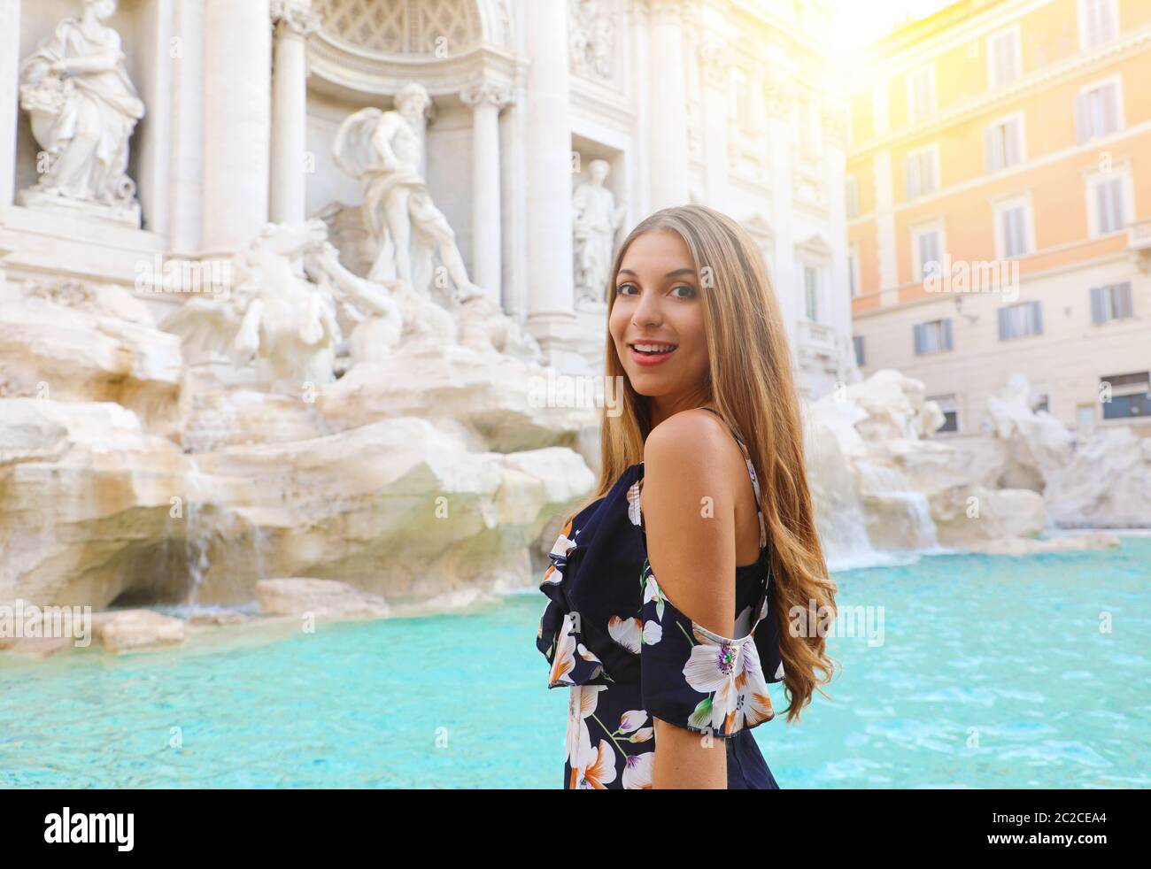 Happy young beautiful fashion woman in Rome with Trevi Fountain in the ...