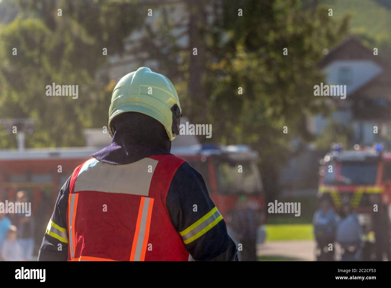 A firefighter in a suit and helmet photo in the back as he goes into ...