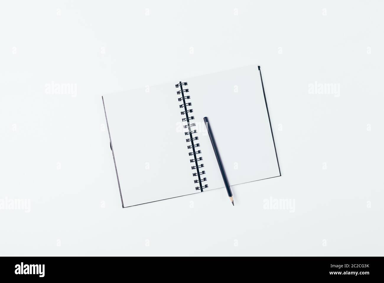 Open blank notebook with pencil on a white desktop, concise flat lay ...