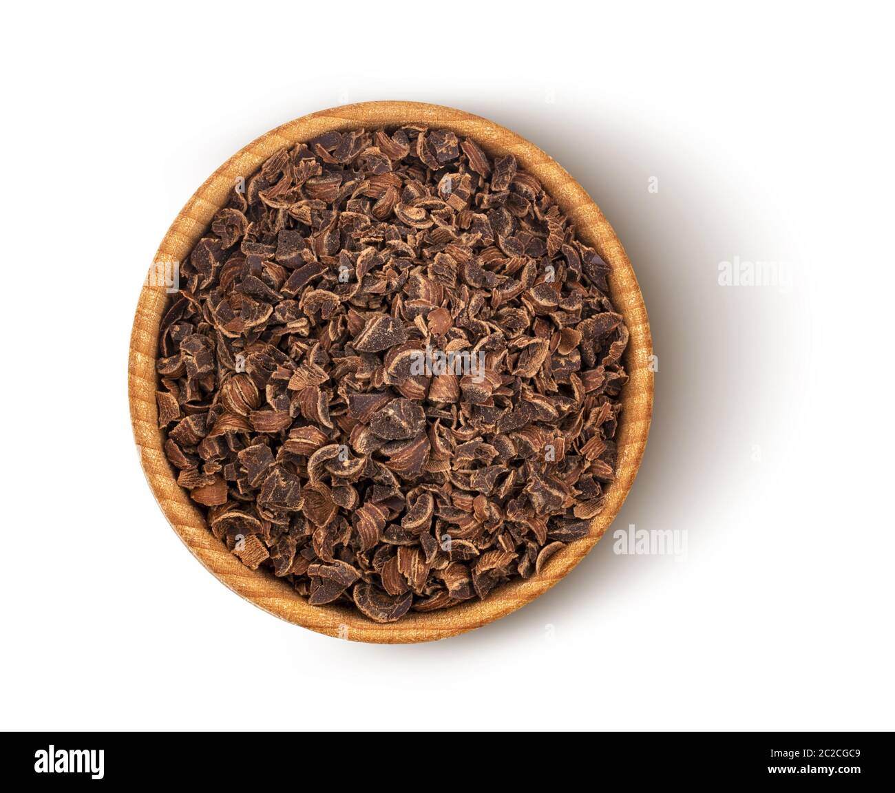 Pile of ground chocolate in wooden bowl isolated on white background ...