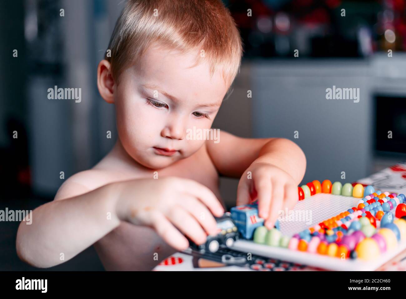 little boy play board game on table mosaic colored Stock Photo - Alamy