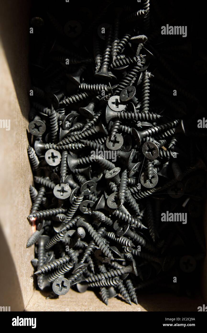 black screws in cardboard box Stock Photo - Alamy