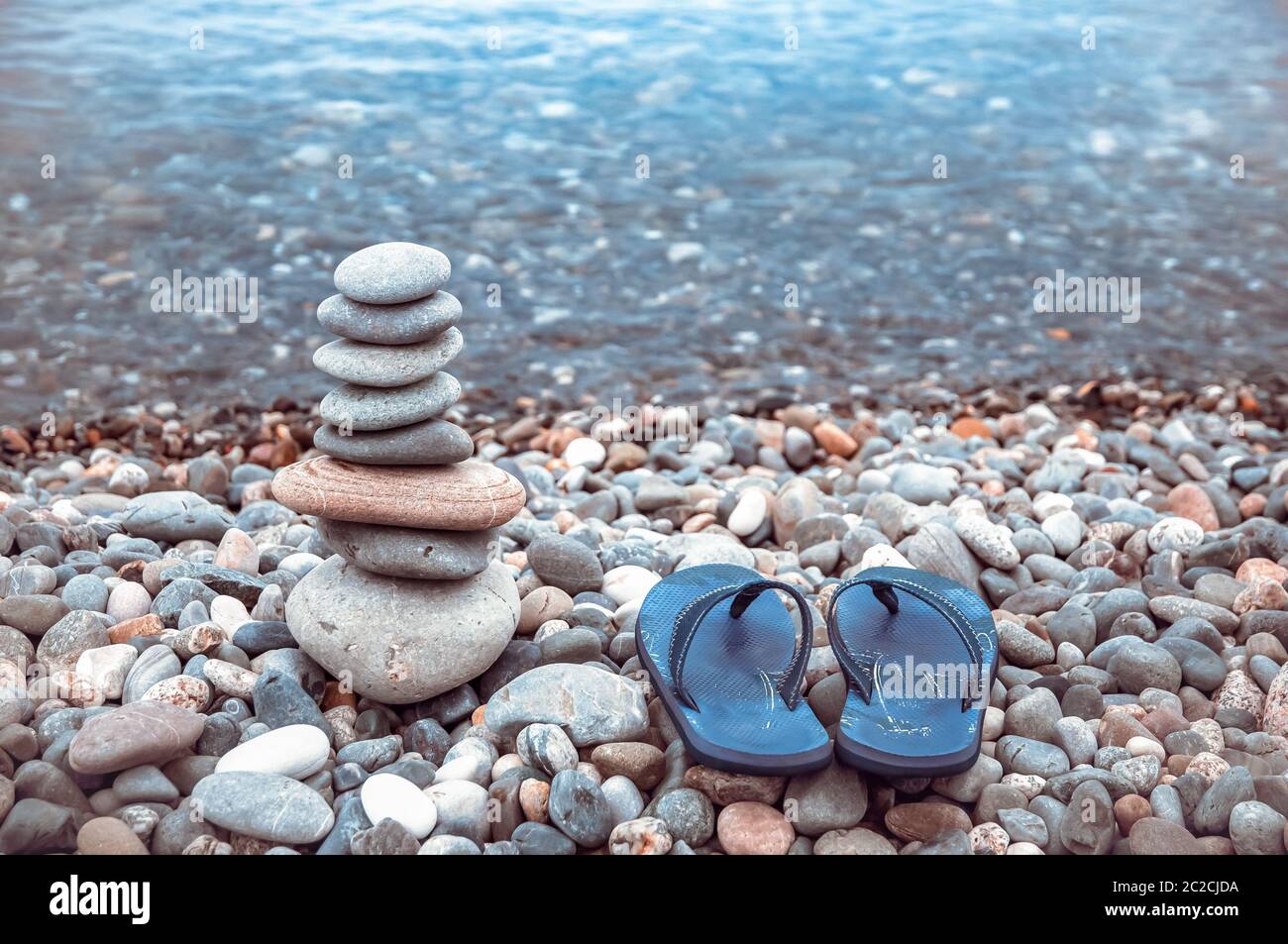 Pyramid of sea stones on pebbles of the sea shore. Seascape. The ...