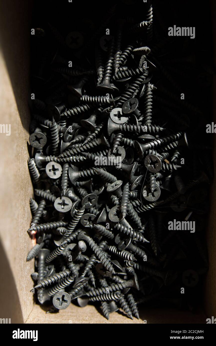 black screws in cardboard box Stock Photo - Alamy