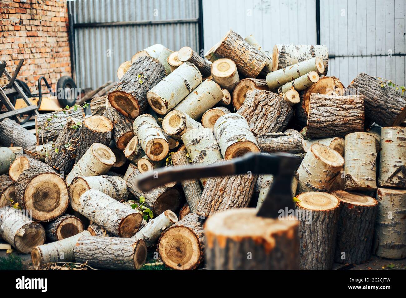 A sharp blade of an ax that sticks out in a wooden chock. rustic ...