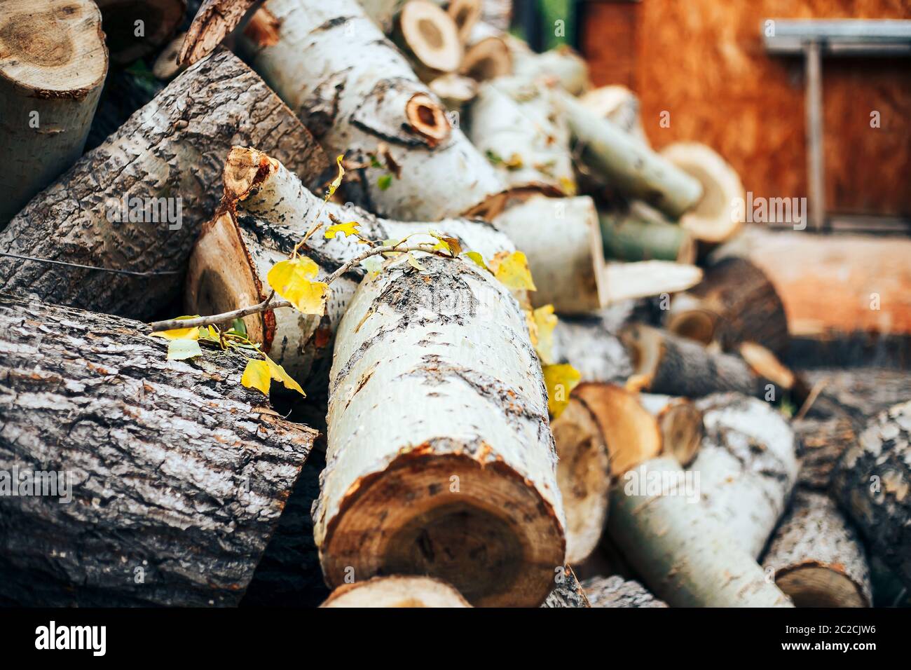 A sharp blade of an ax that sticks out in a wooden chock. rustic ...