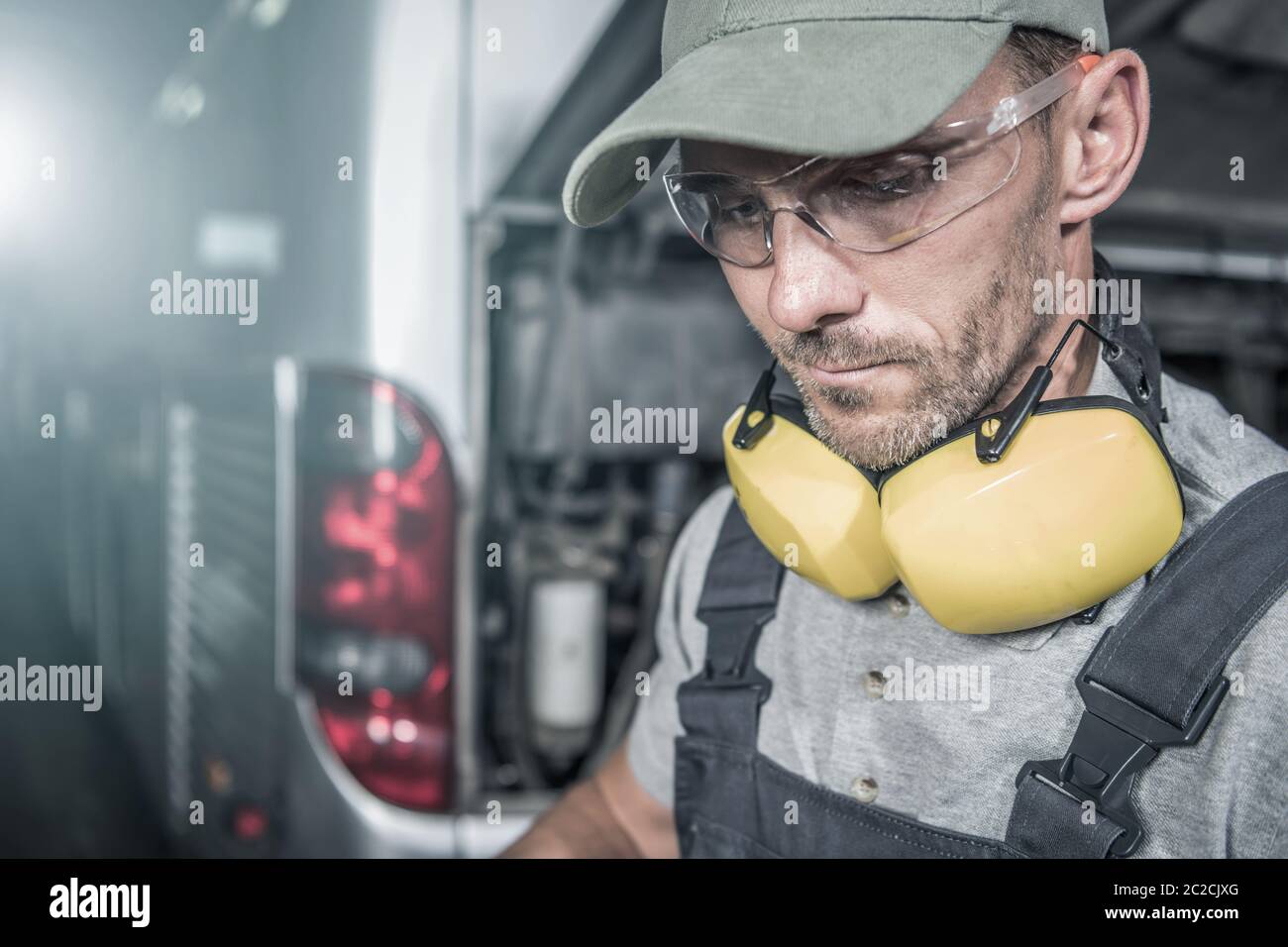 Coach Buses and Trucks Mechanic Job. Caucasian Bus Technician in Eye ...