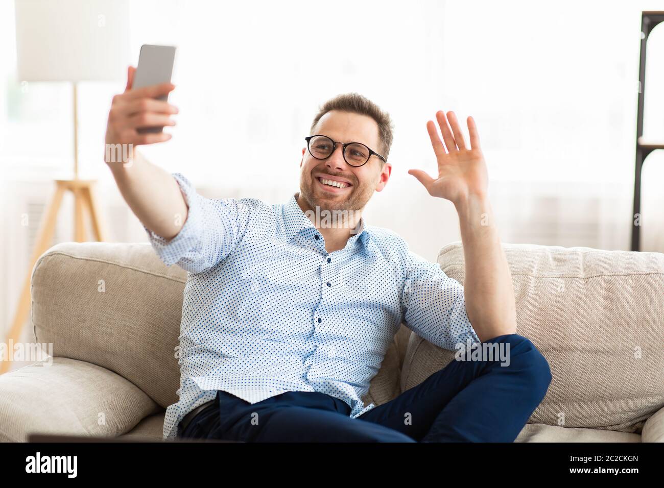 Happy man using mobile phone for video call Stock Photo - Alamy
