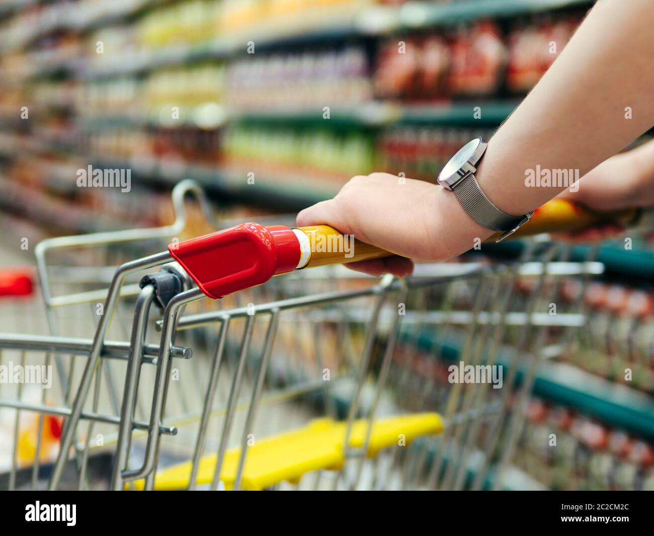 shopping cart in supermarket aisle, copy space Stock Photo - Alamy