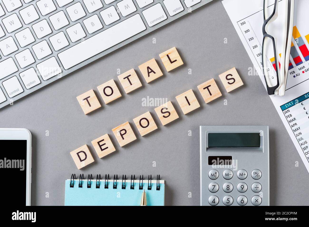 Total deposits concept with letters on cubes Stock Photo - Alamy