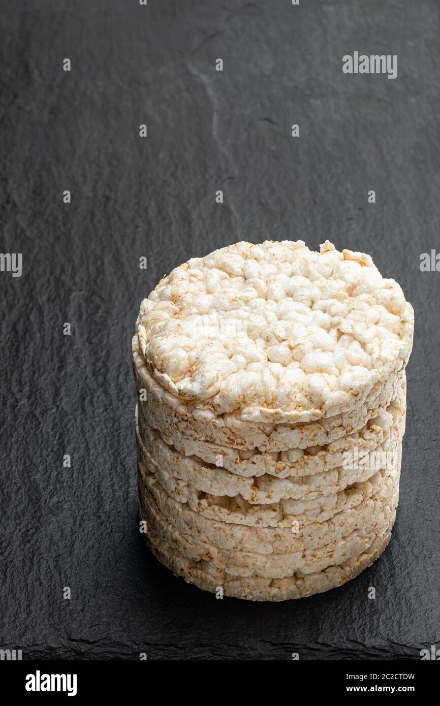 Stack of rice crackers on black stone bachground Stock Photo - Alamy