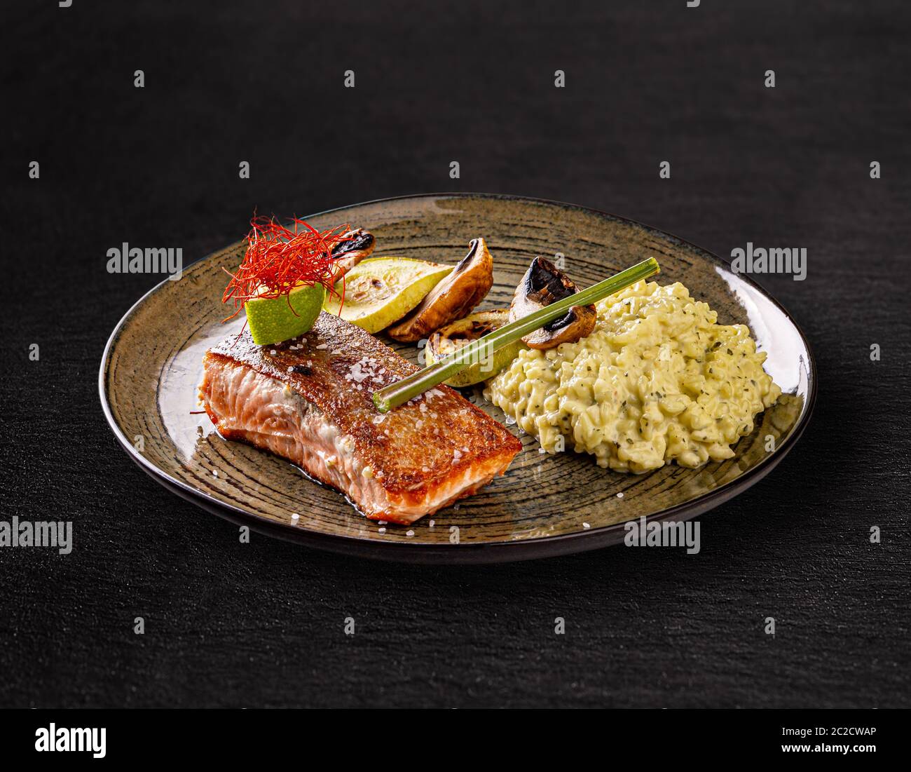 Grilled salmon served with grilled zucchini, champignon and basil ...