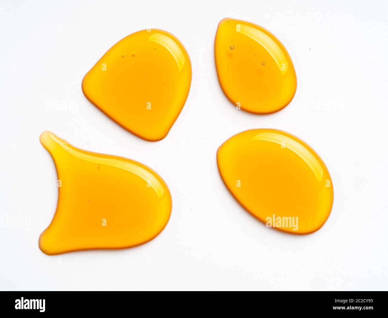 Honey drops, isolated on white Stock Photo - Alamy