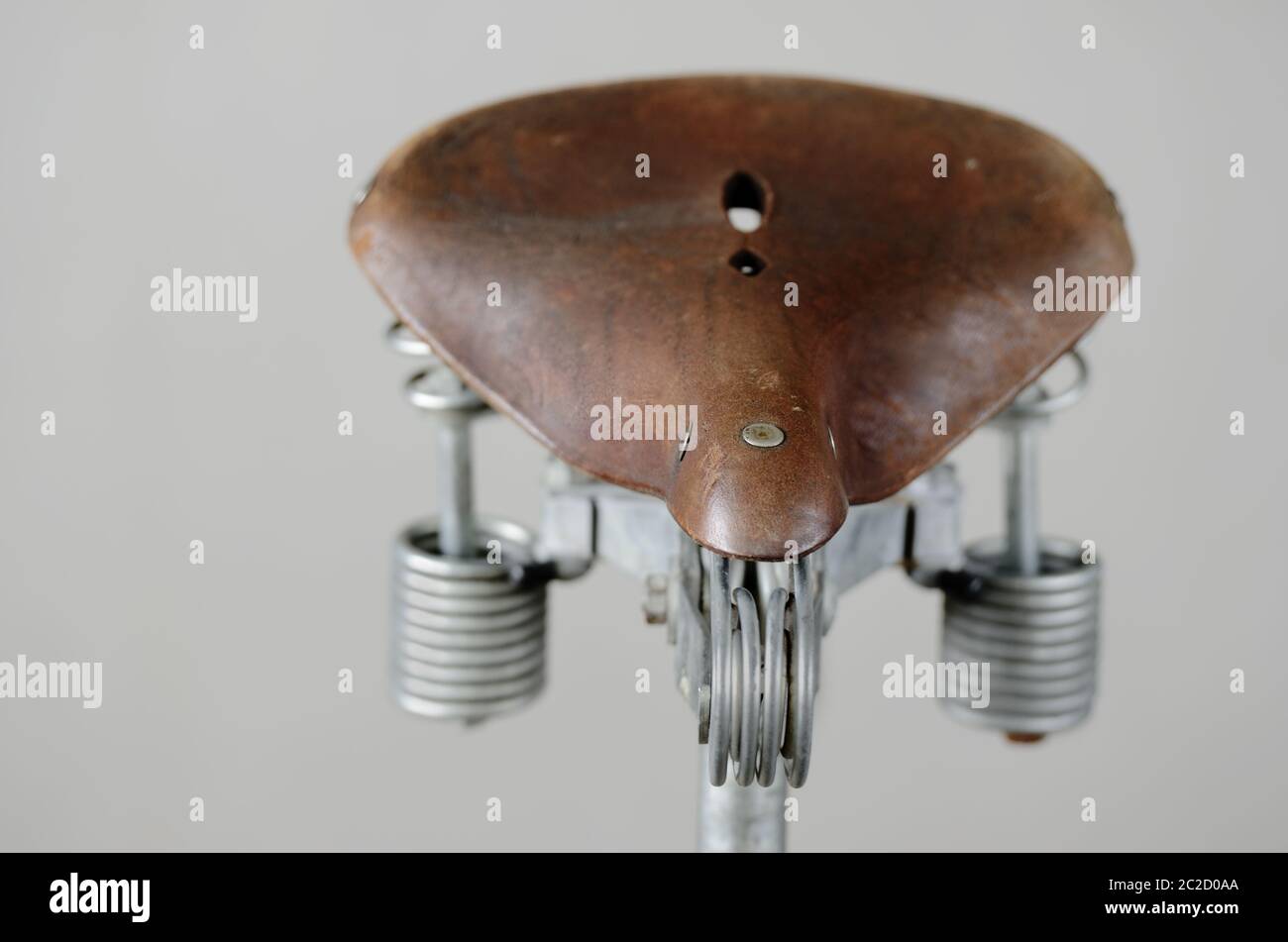 old-fashioned vintage leather bike saddle with metal spring Stock Photo ...