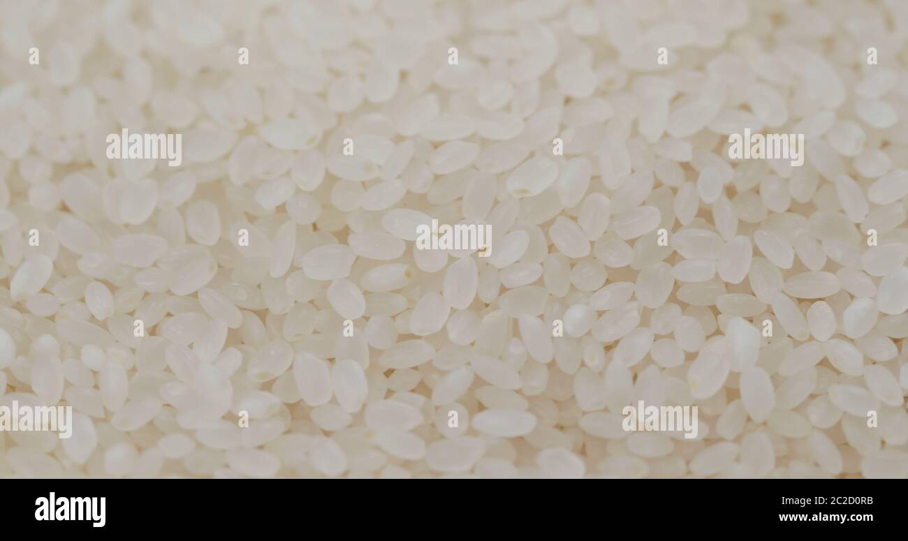 White uncooked rice in stack Stock Photo - Alamy