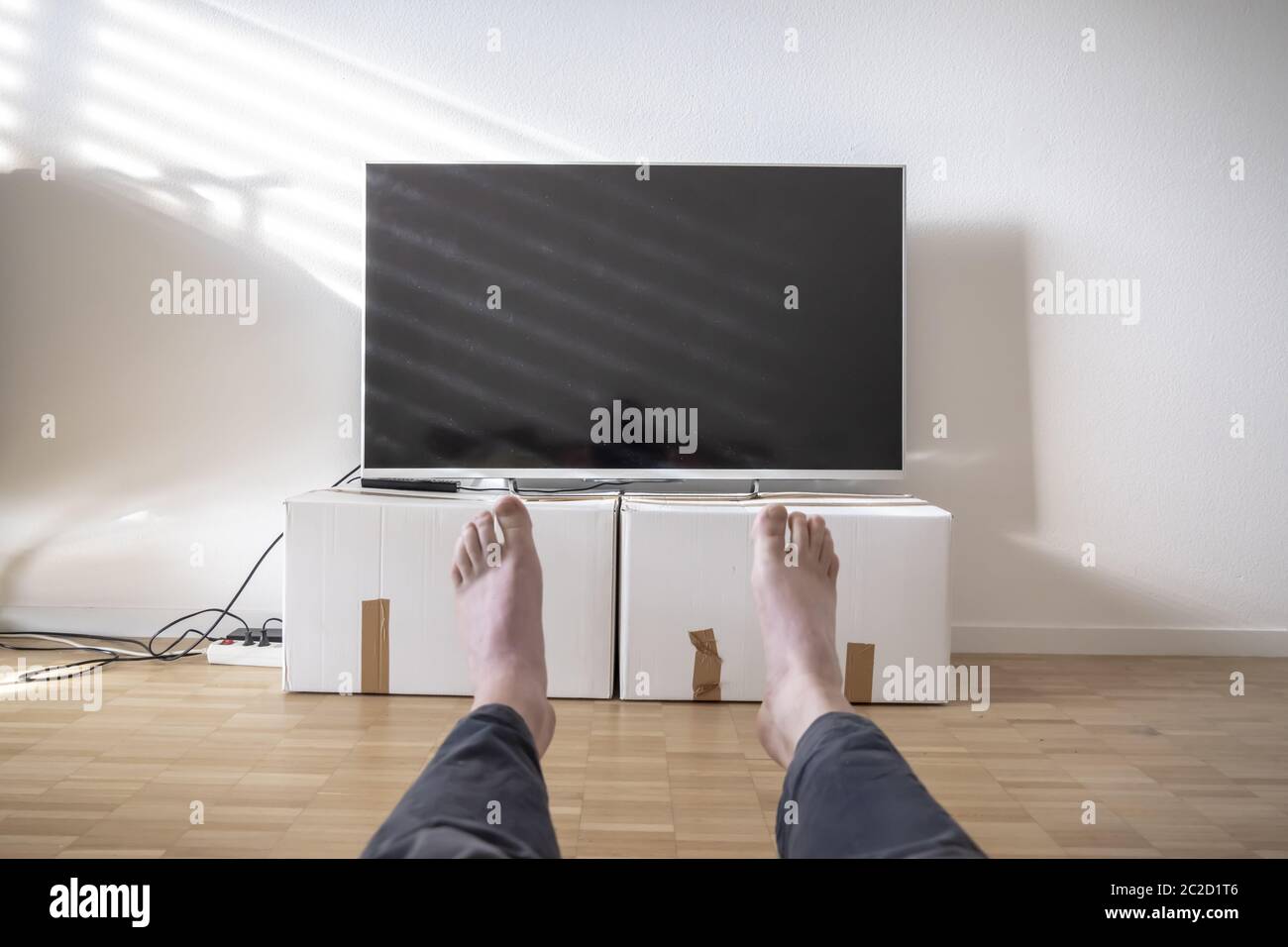 Television on Cardboard Box in Living Room and Men Legs in Switzerland ...