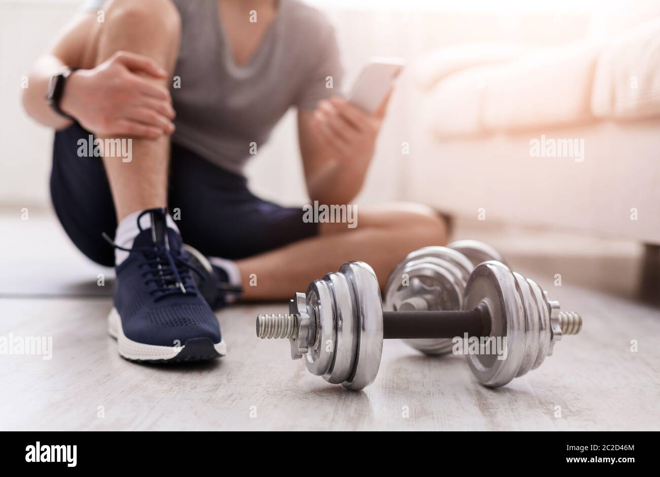 Track activity of body. Man with smart watch watches at phone, sitting ...