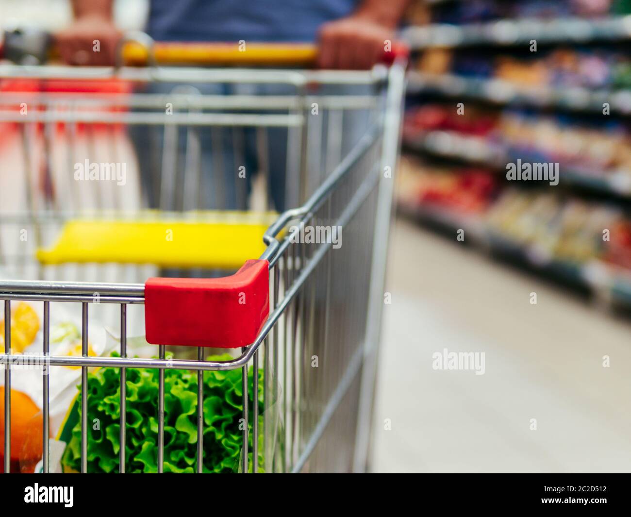 shopping cart in supermarket aisle, copy space Stock Photo - Alamy