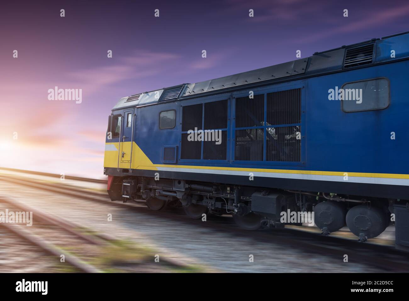 Fast freight blue train at sunset with motion blur Stock Photo - Alamy