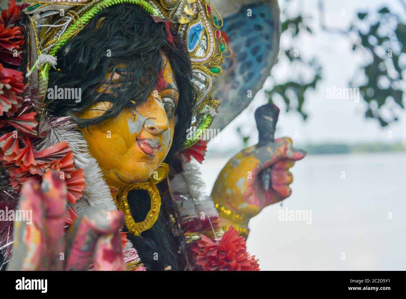 A Devi Maa Durga sadly looks down with tousled hair while tears flow ...
